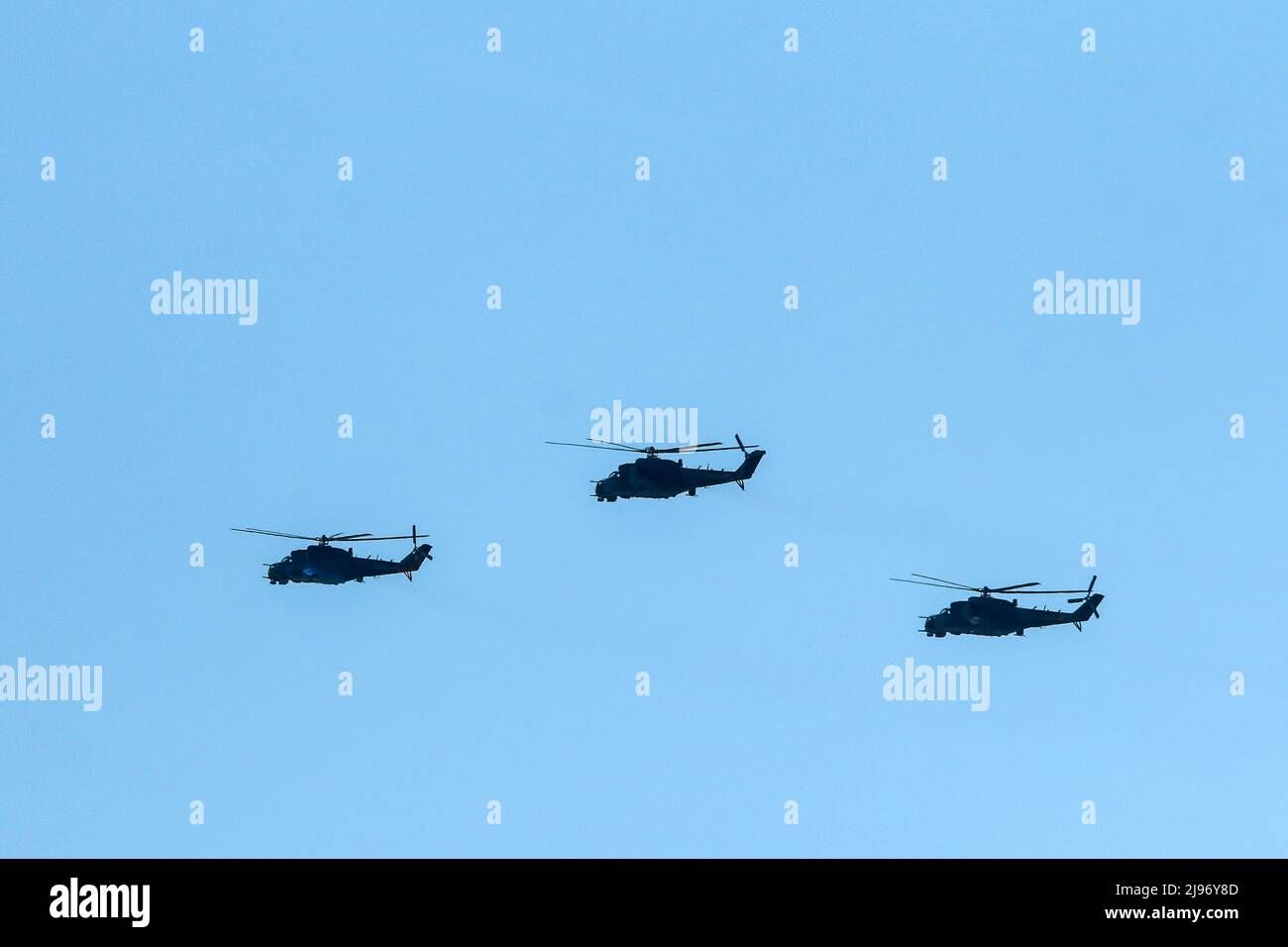 The flight of three soviet battle helicopters, type MIL Mi-24 flying on ...