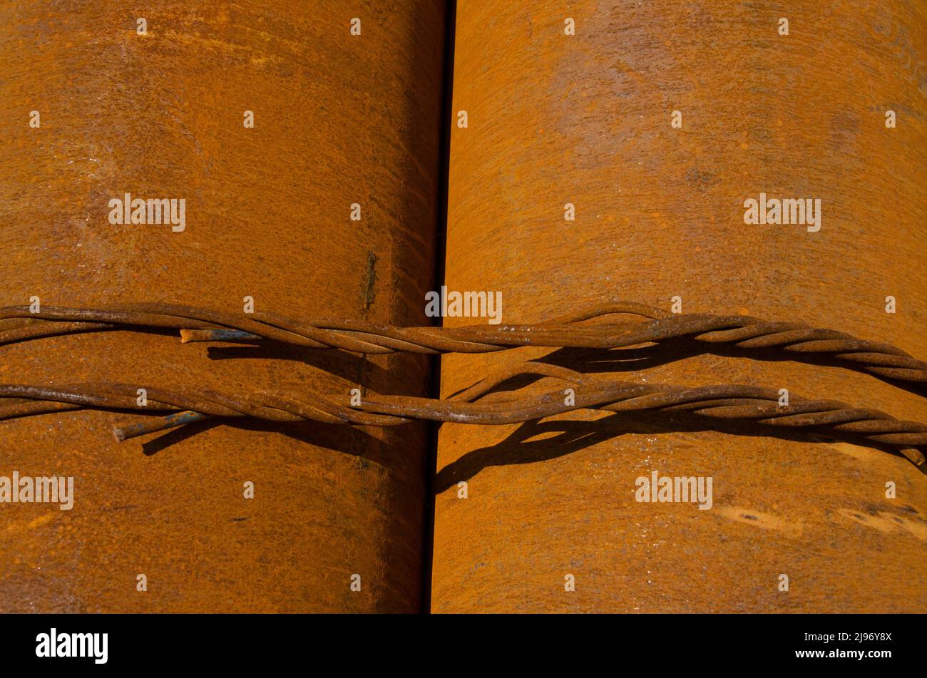 Close-up of two rusty round steel bars bound with wire looking like a ...