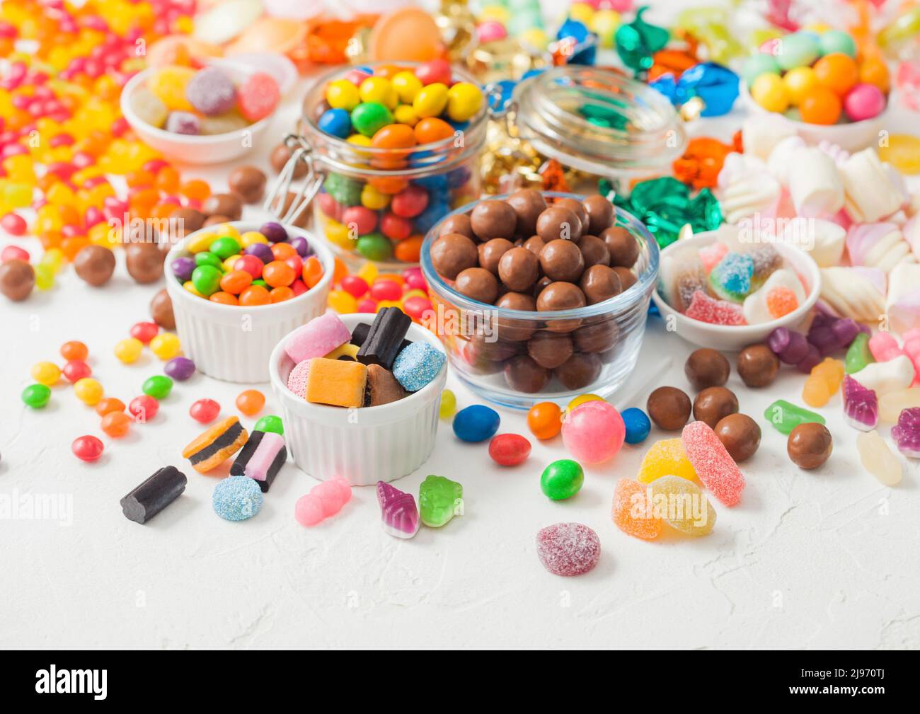 Milk chocolate candies woth shell in jar with various jelly gums ...
