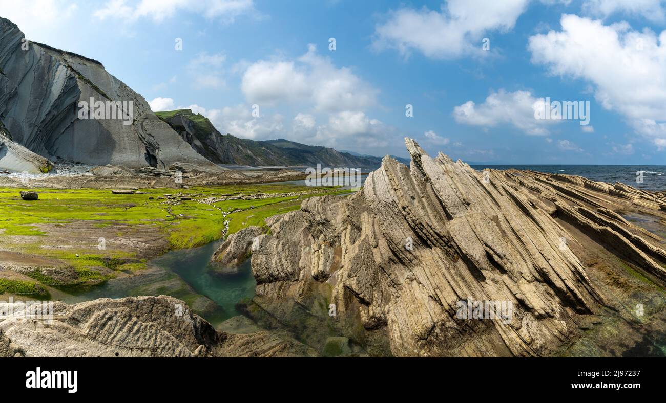 A panorama view of the Flysch rock formations and cliffs with tidal ...