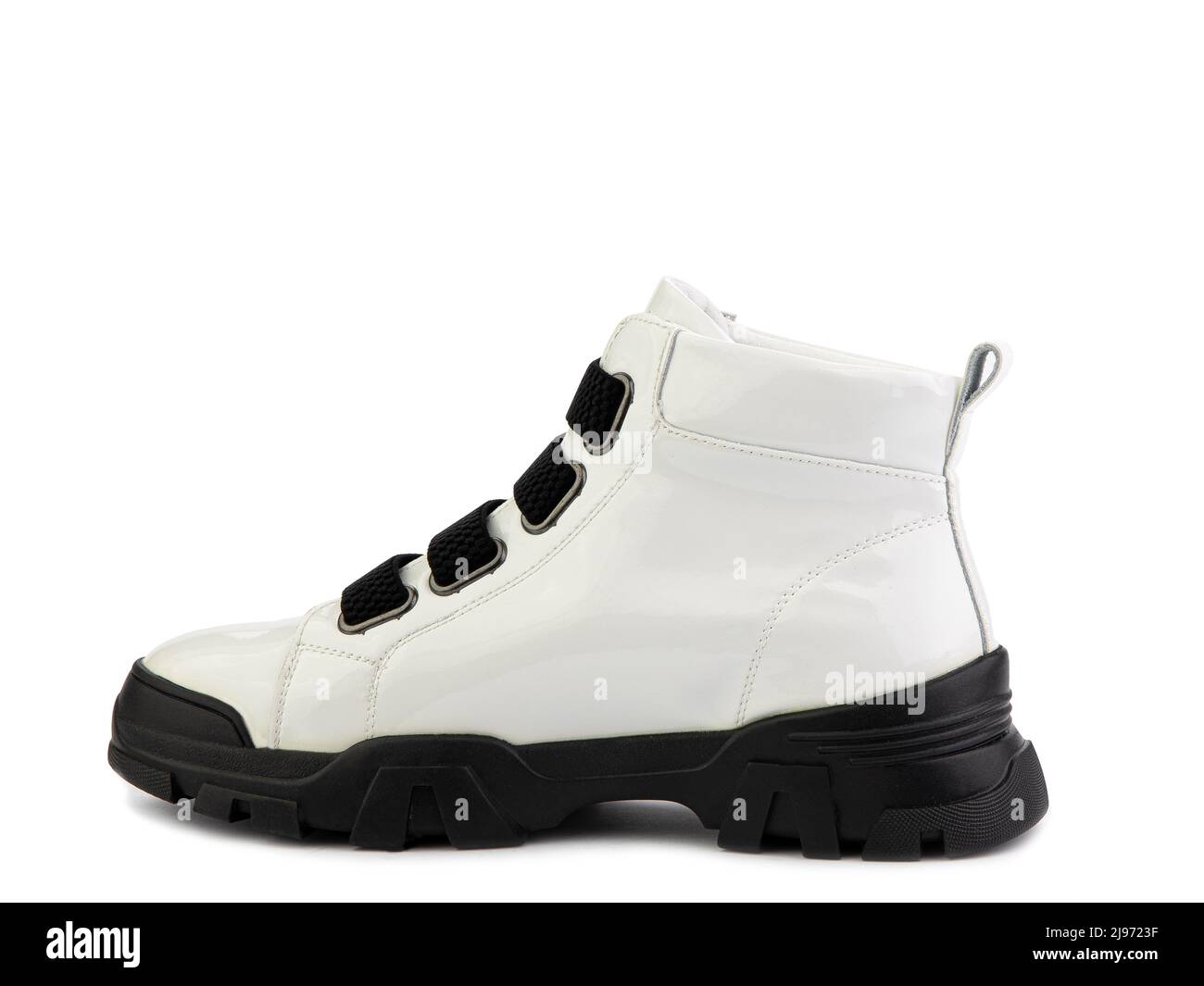 White leather ankle boots with black big laces. Isolated close-up on ...