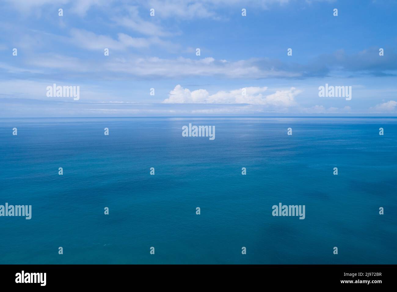 Aerial view of a blue sea surface water texture background and sun ...