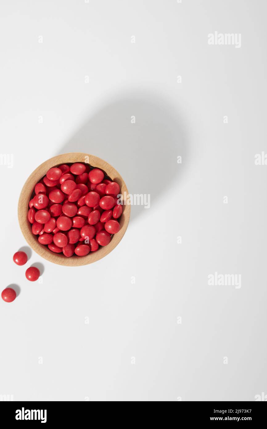 Red Chocolate Candy Pills in Bowl Isolated on White Background Stock ...