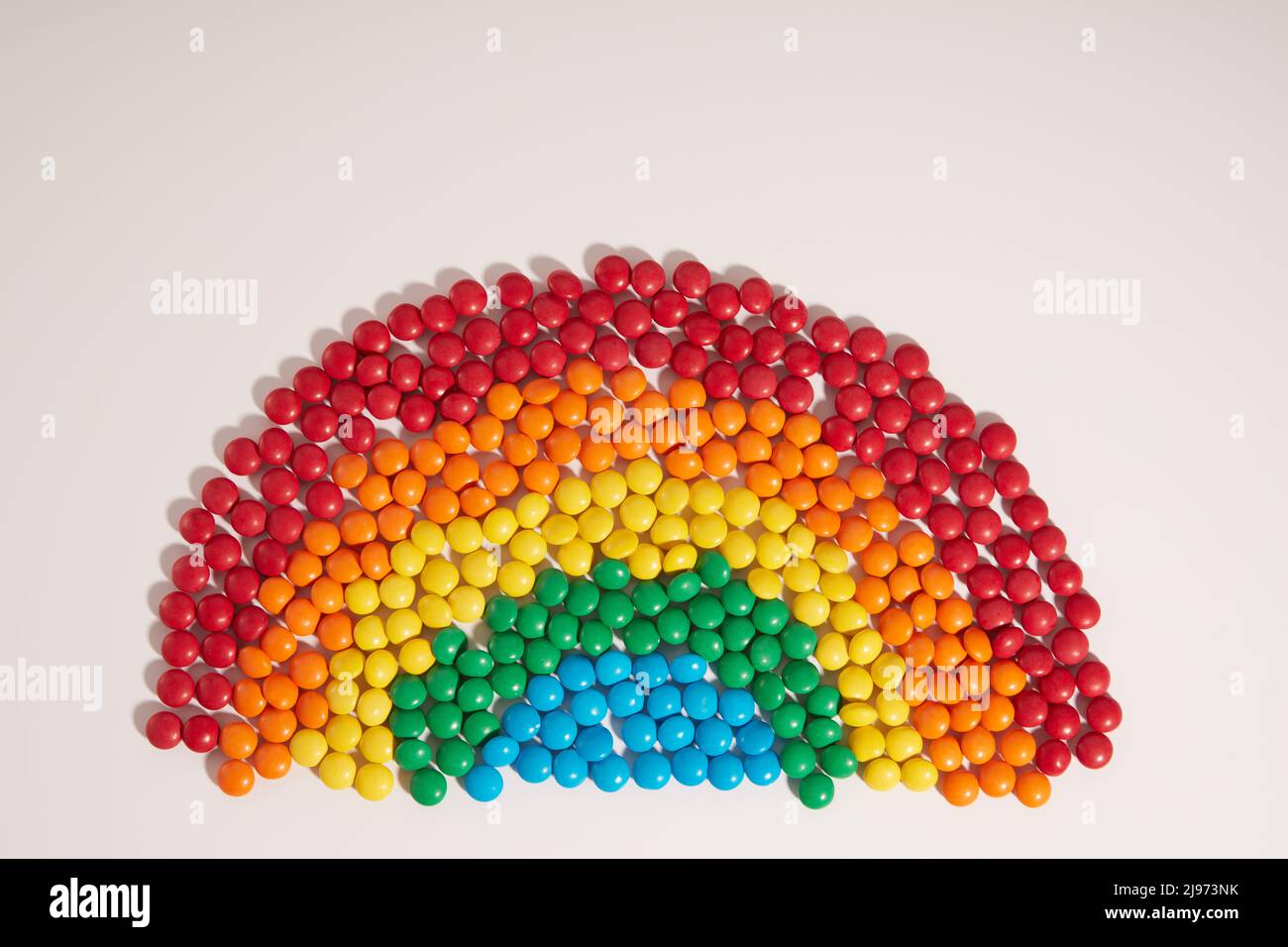 Candy rainbow shape on white background Stock Photo - Alamy