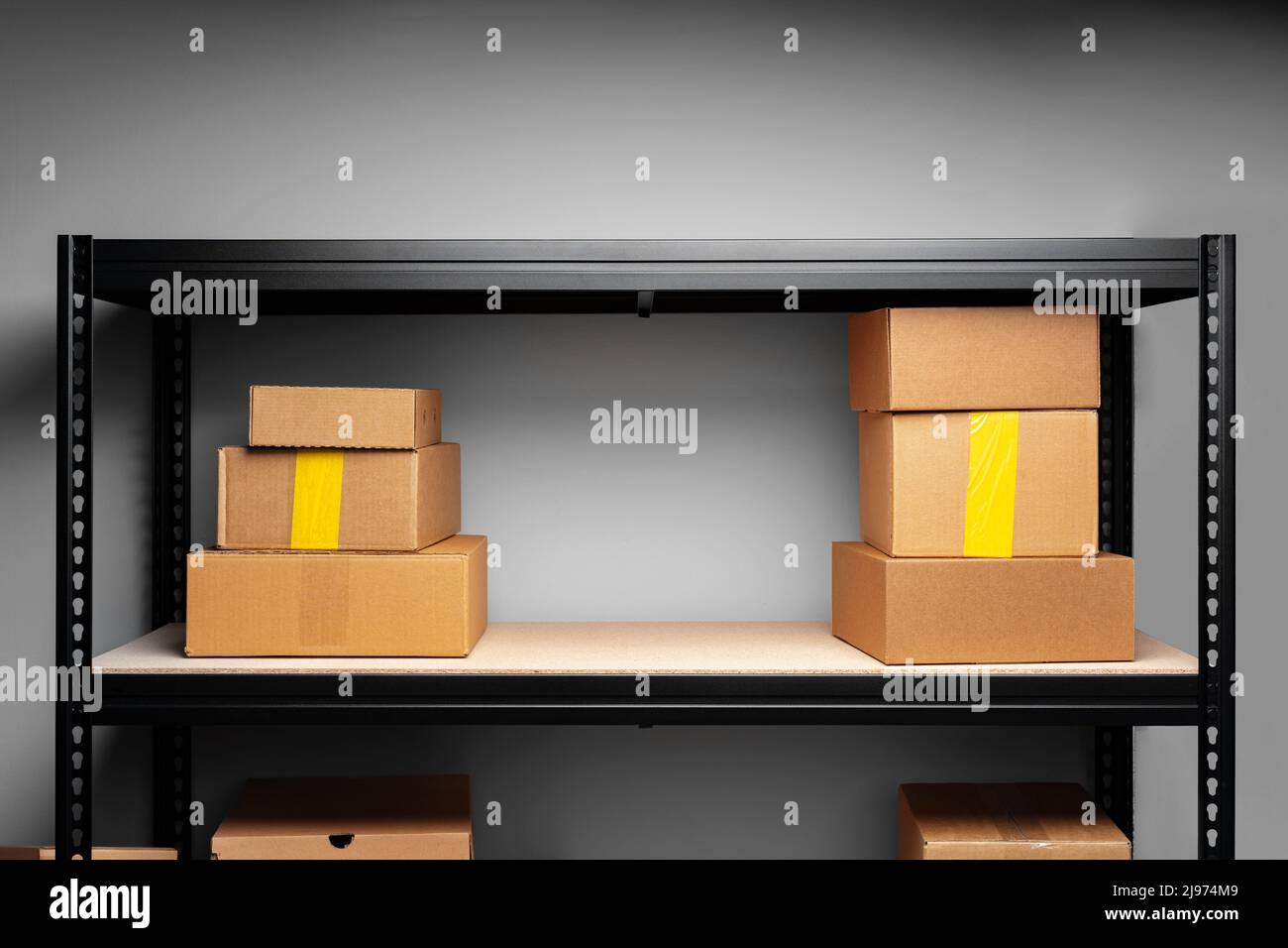 Rows of shelves with cardboard boxes in modern warehouse Stock Photo ...