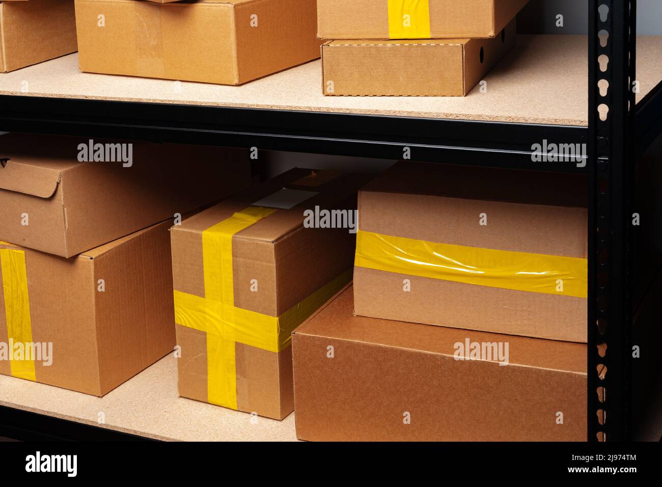 Rows of shelves with cardboard boxes in modern warehouse Stock Photo ...