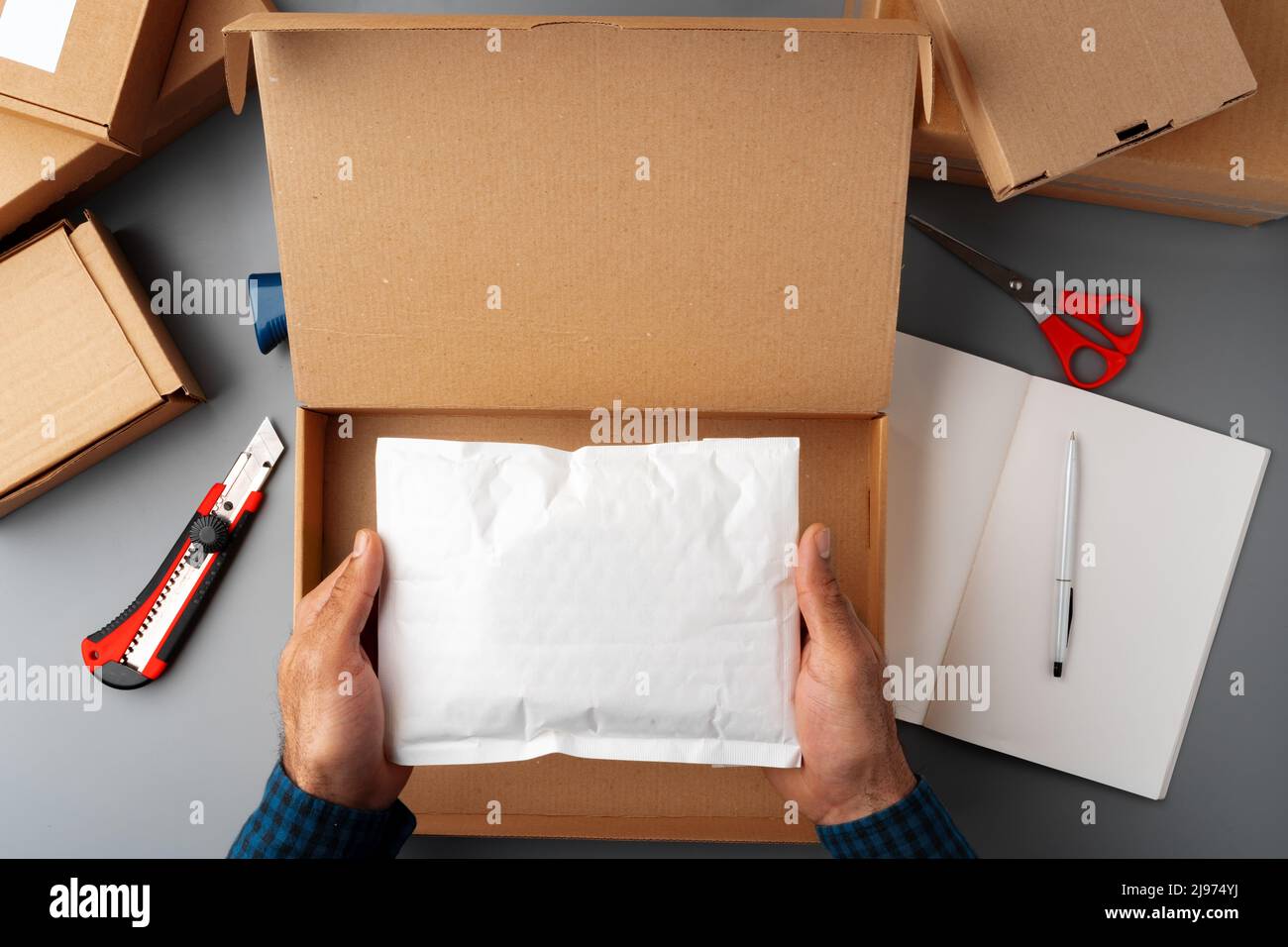 Above table top view of warehouse preparing post courier delivery ...