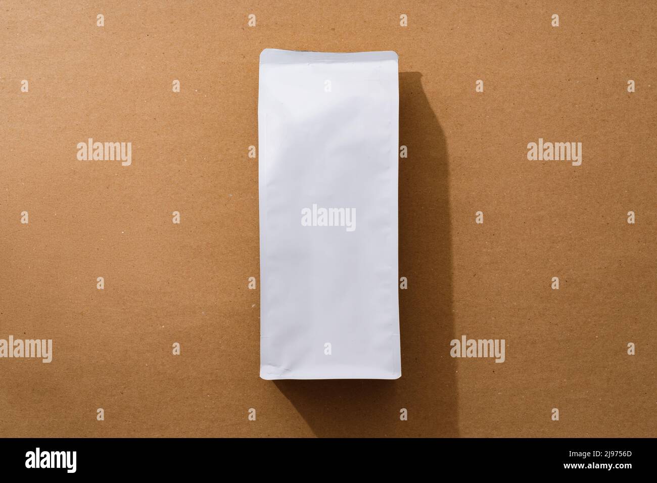 Blank package with coffee beans for your design on beige background ...