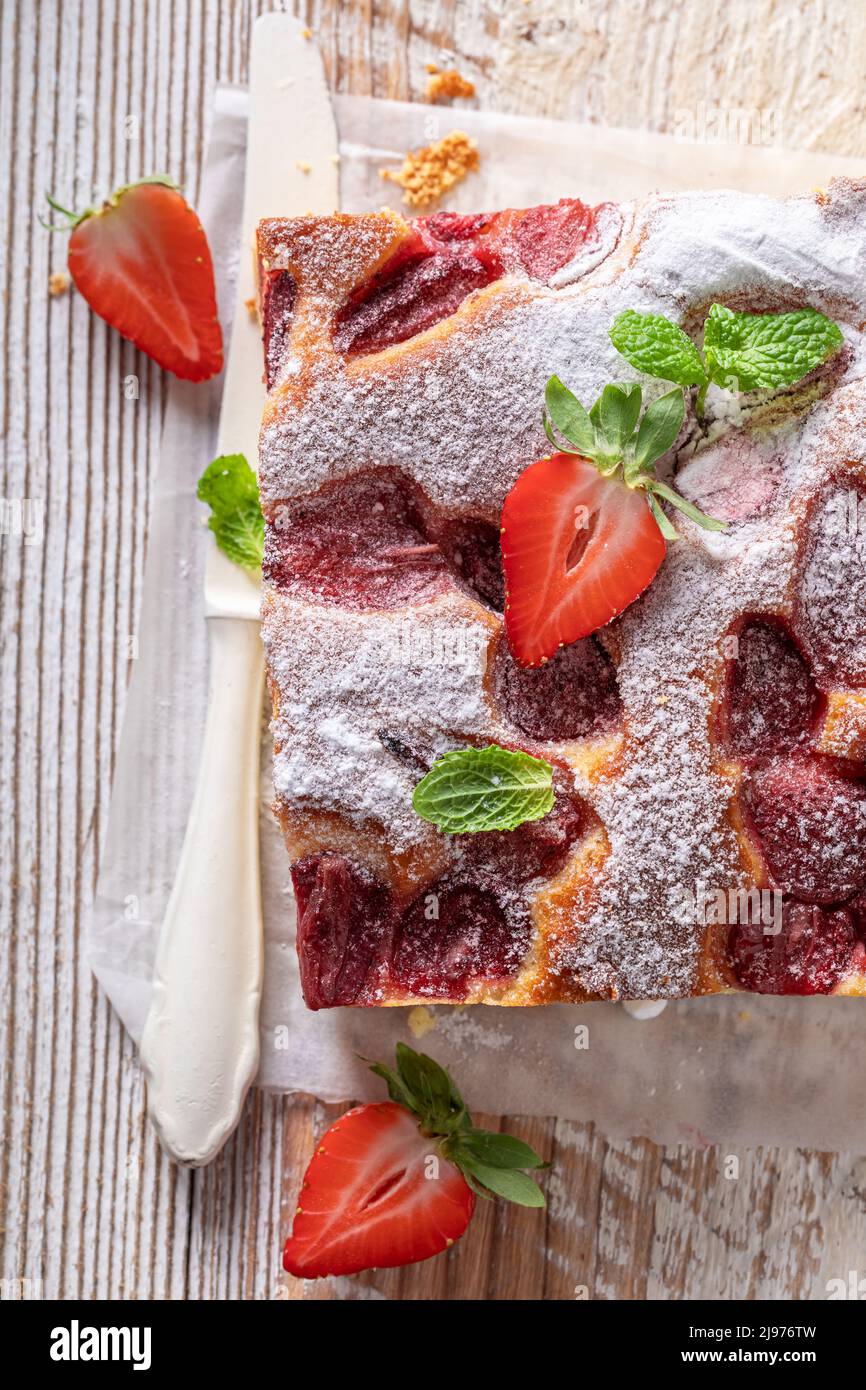 Homemade and delicious strawberry cake with caster sugar and berries ...