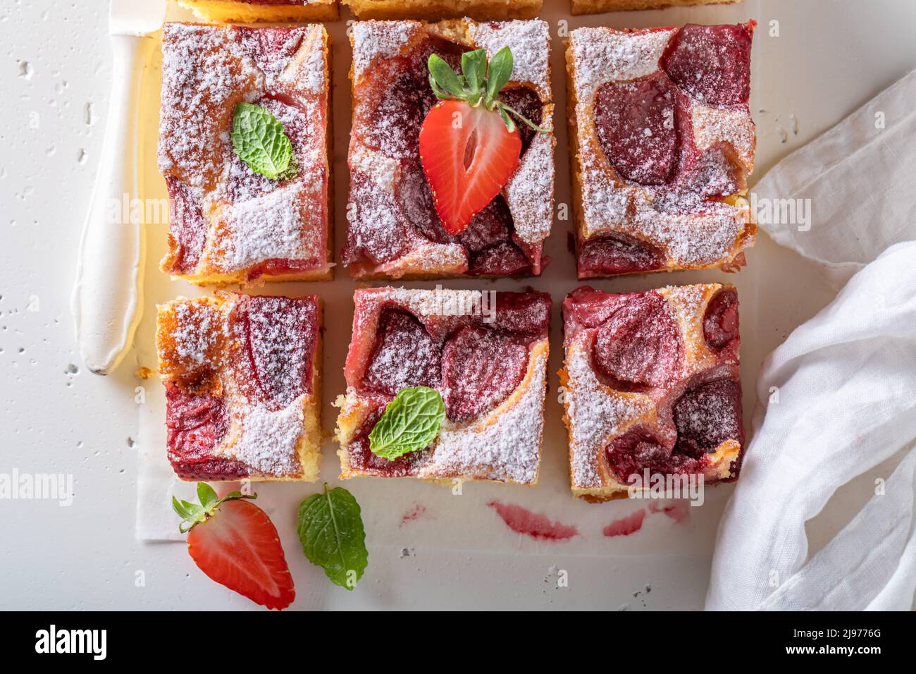 Homemade and sweet strawberry cake with caster sugar and berries ...