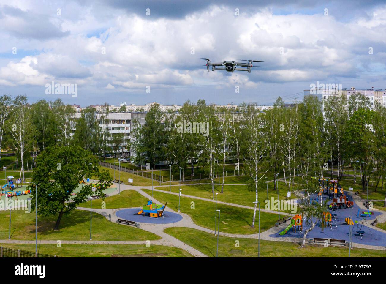 flying drone over the city residential area and childrens playgrounds ...