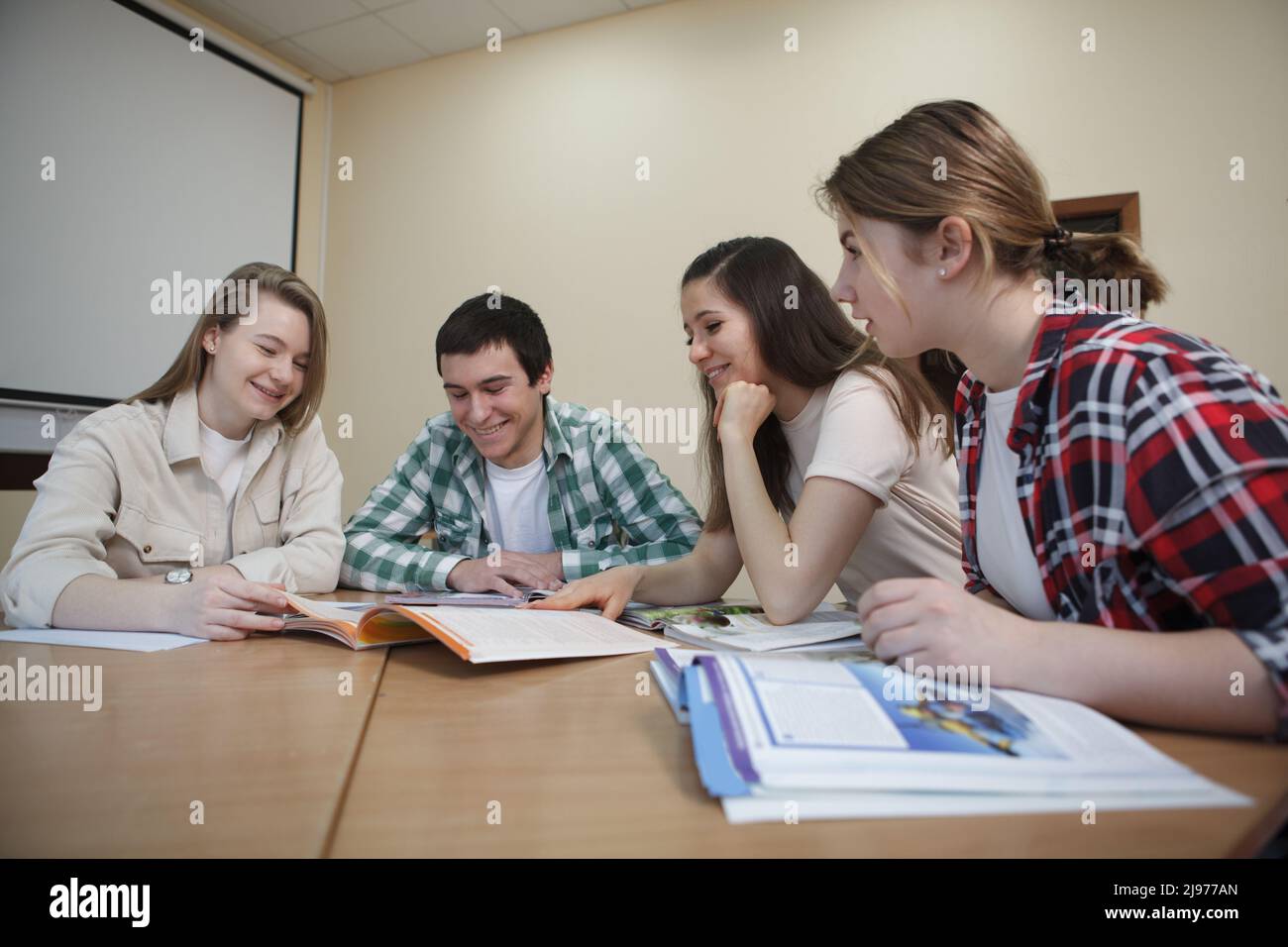 Group of college students talking in class Stock Photo - Alamy