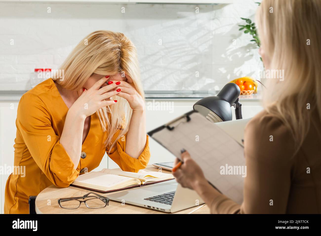 Psychologist comforting a depressed woman during a mental therapy ...