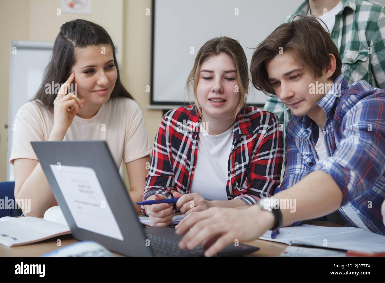 College students using laptop, studying together in class Stock Photo - Alamy