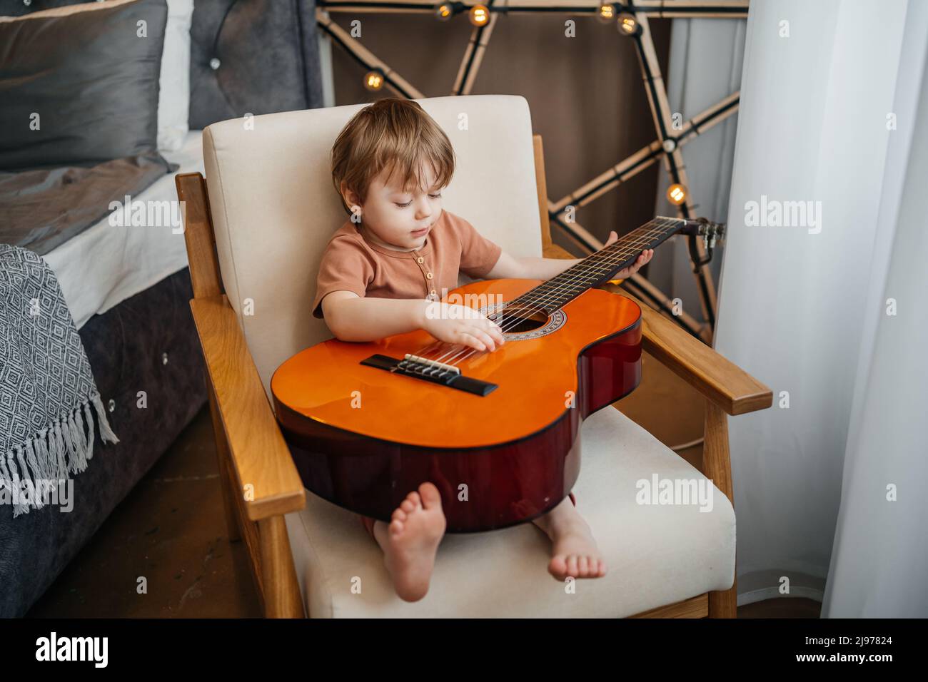 little boy playing classical guitar Stock Photo - Alamy