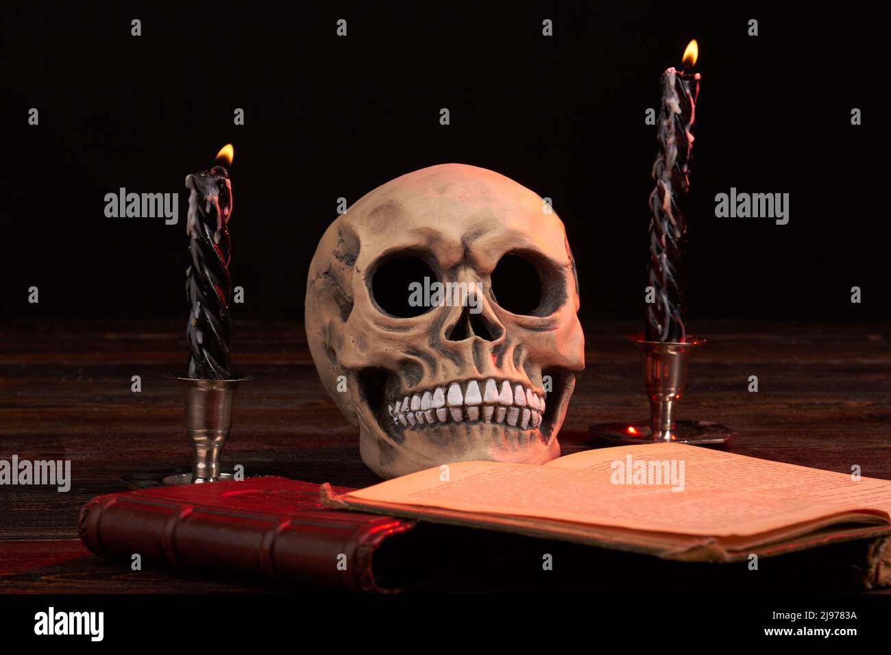 Satanic composition of humans skull with satanic book and burning ...