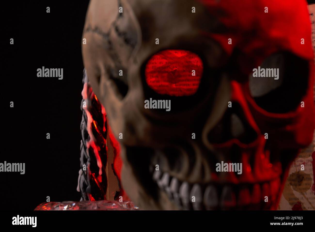 Close-up creepy humans skull with red lighting on black background ...