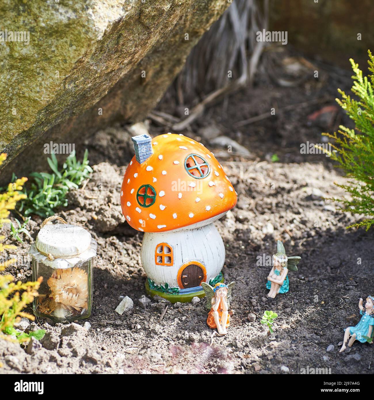 Toadstool house at the bottom of the garden surrounded by fairy folk ...