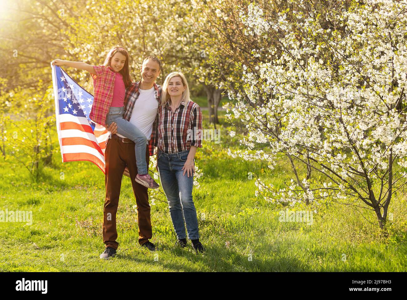 July 4th: American Family Behind US Flag Stock Photo - Alamy