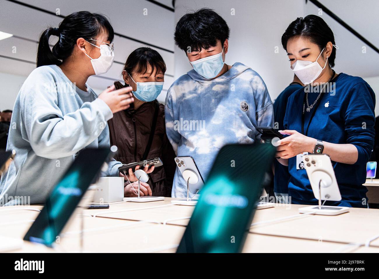 Wuhan, China. 21st May, 2022. Apple staff and customers are seen at the ...