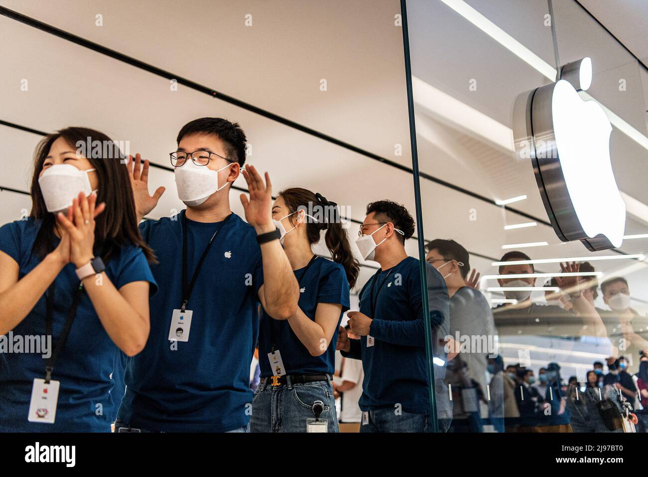 Wuhan, China. 21st May, 2022. Apple staff wearing masks welcome ...