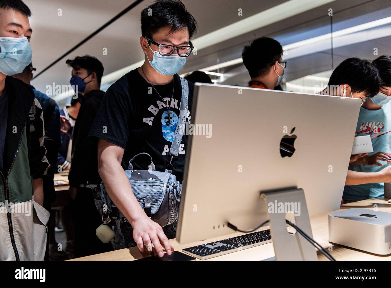 Wuhan, China. 21st May, 2022. Chinese customers wearing masks try an ...