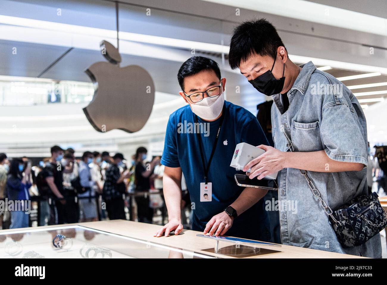 Apple staff and customers are seen at the official opening of the new ...