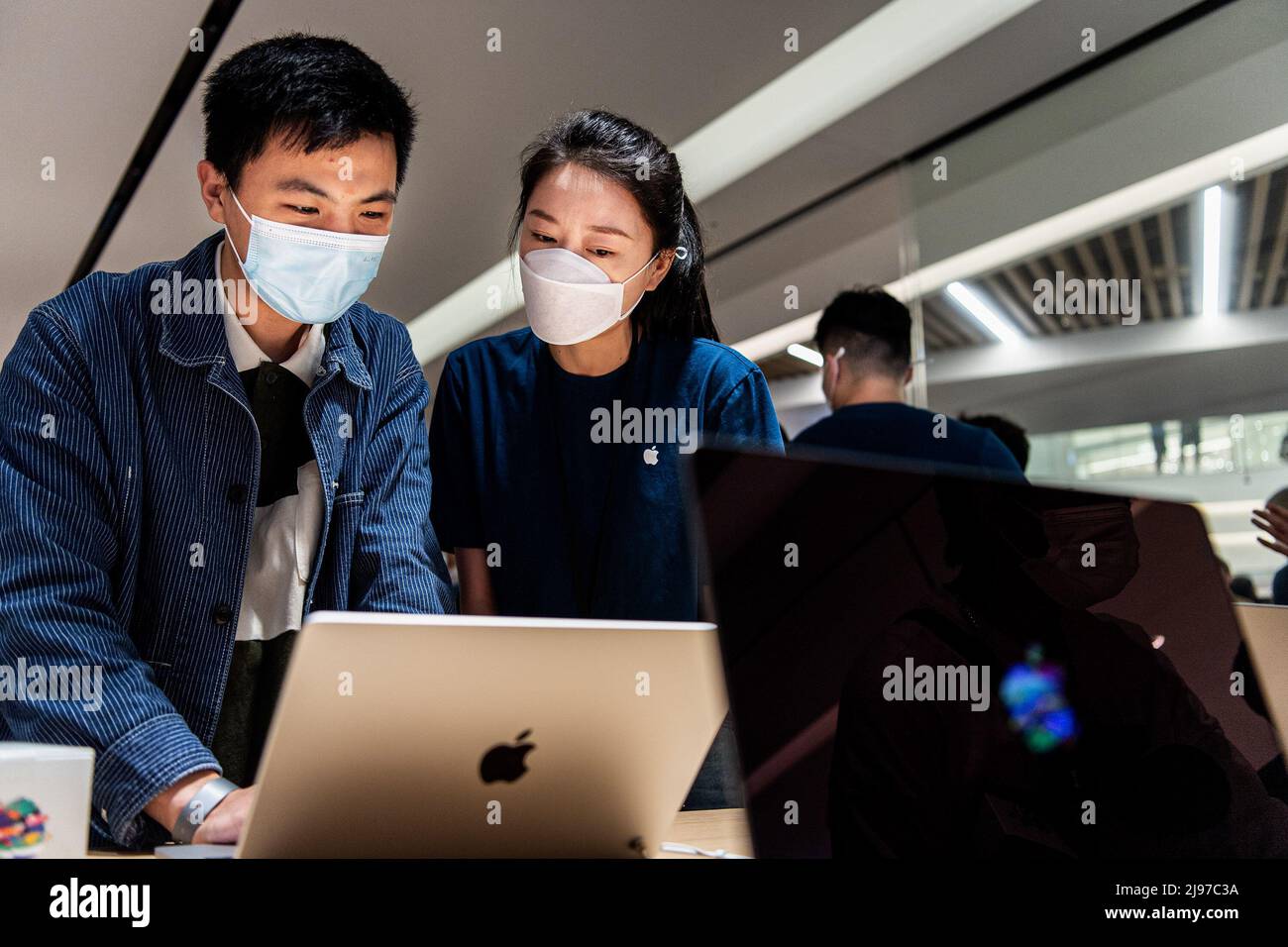 Wuhan, China. 21st May, 2022. Apple staff and customers are seen at the ...