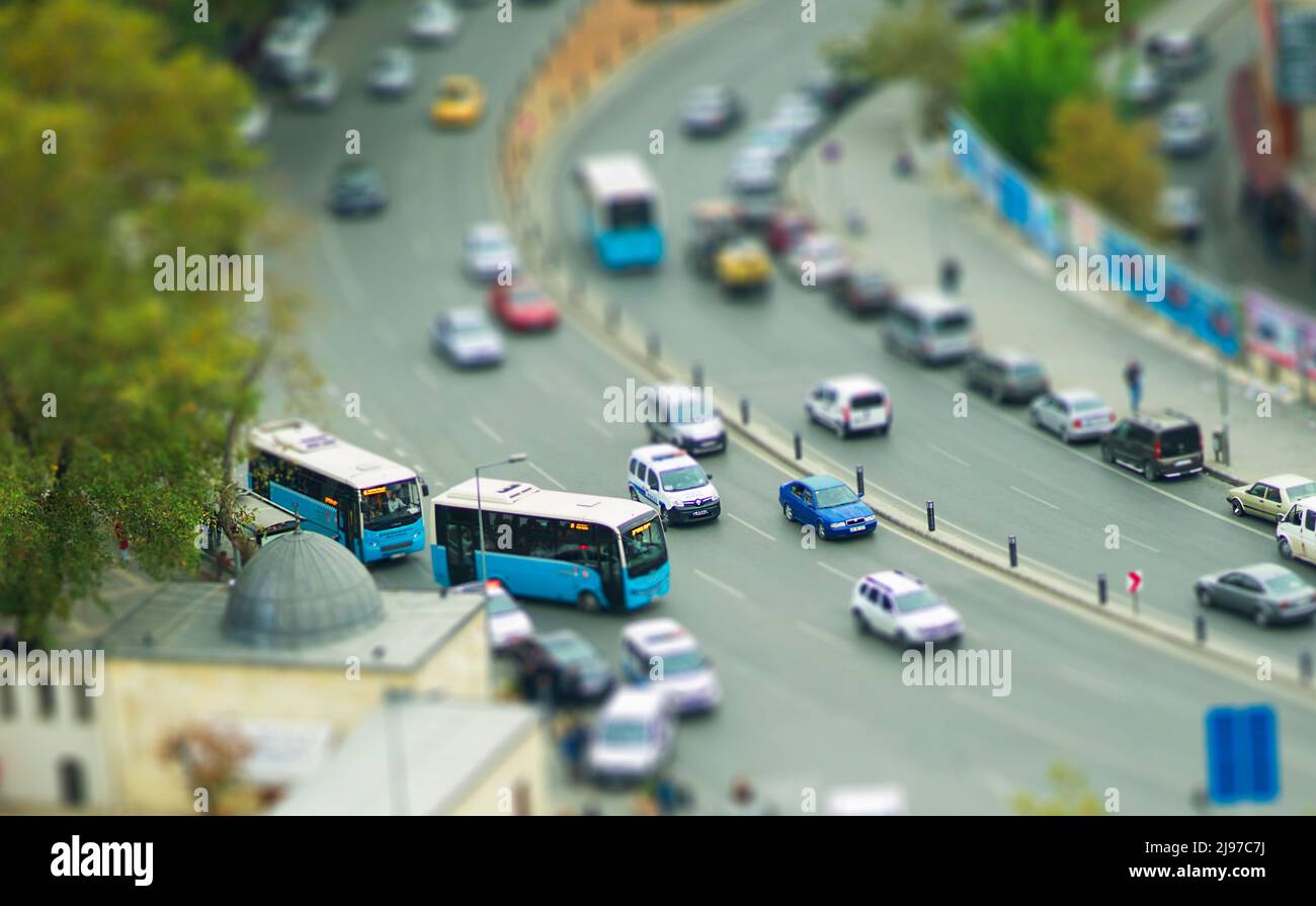 tilt shift effect aerial photography of traffic and road with busses ...