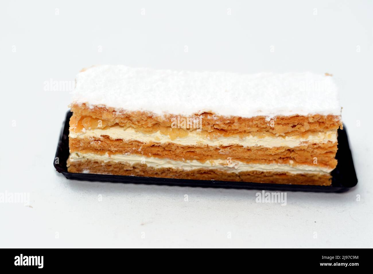Classic powdered sugar Mille feuille cake gateau made of milk, egg ...