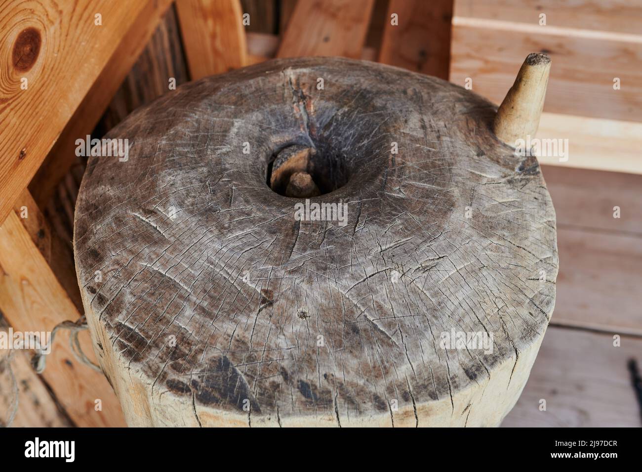 An ancient hand mill made of stones and wood. Flour grinding device ...