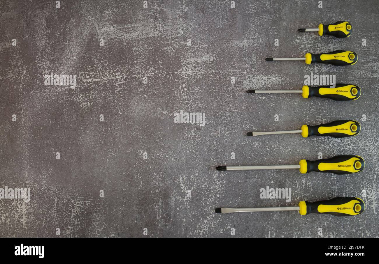 Professional set of screwdrivers on a gray background Stock Photo - Alamy