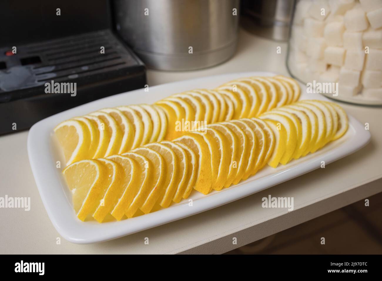 Yellow sliced lemons places on a table overlapping each other. Background texture of fresh ...