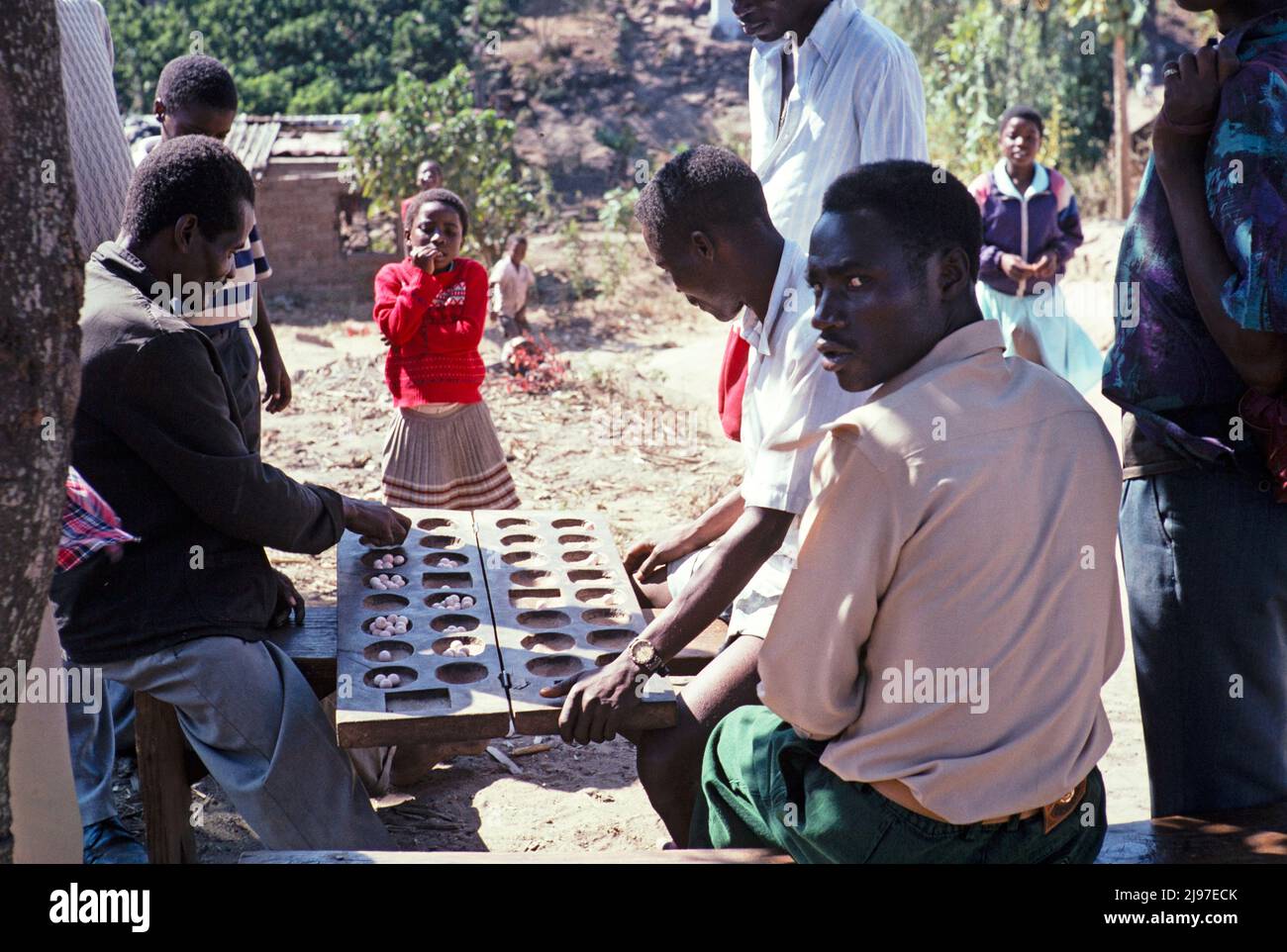 Men playing Bao, a traditional mancala board game, Malawi, southern ...