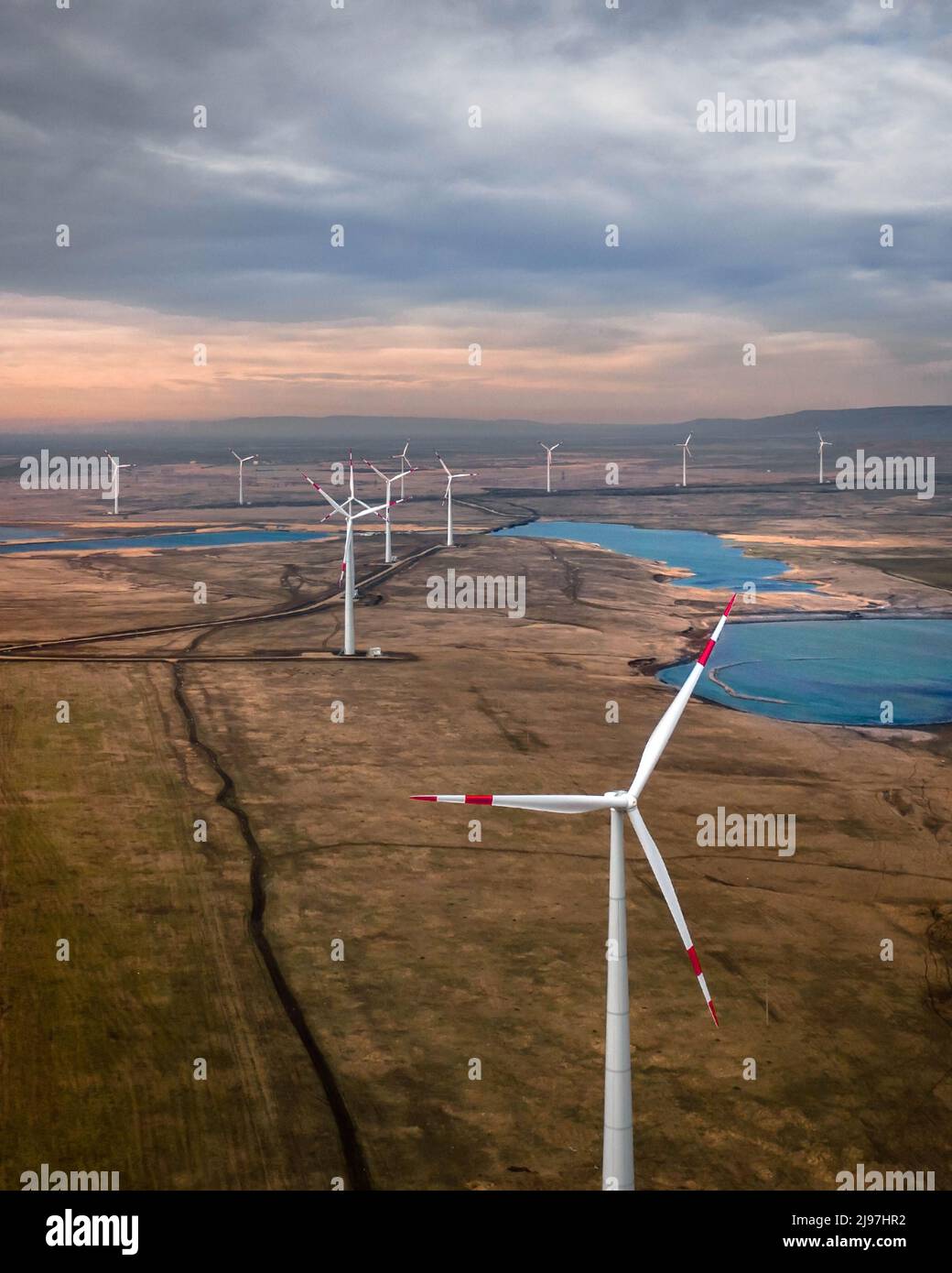 Wind turbine farm at sunset. Renewable energy concept Stock Photo - Alamy