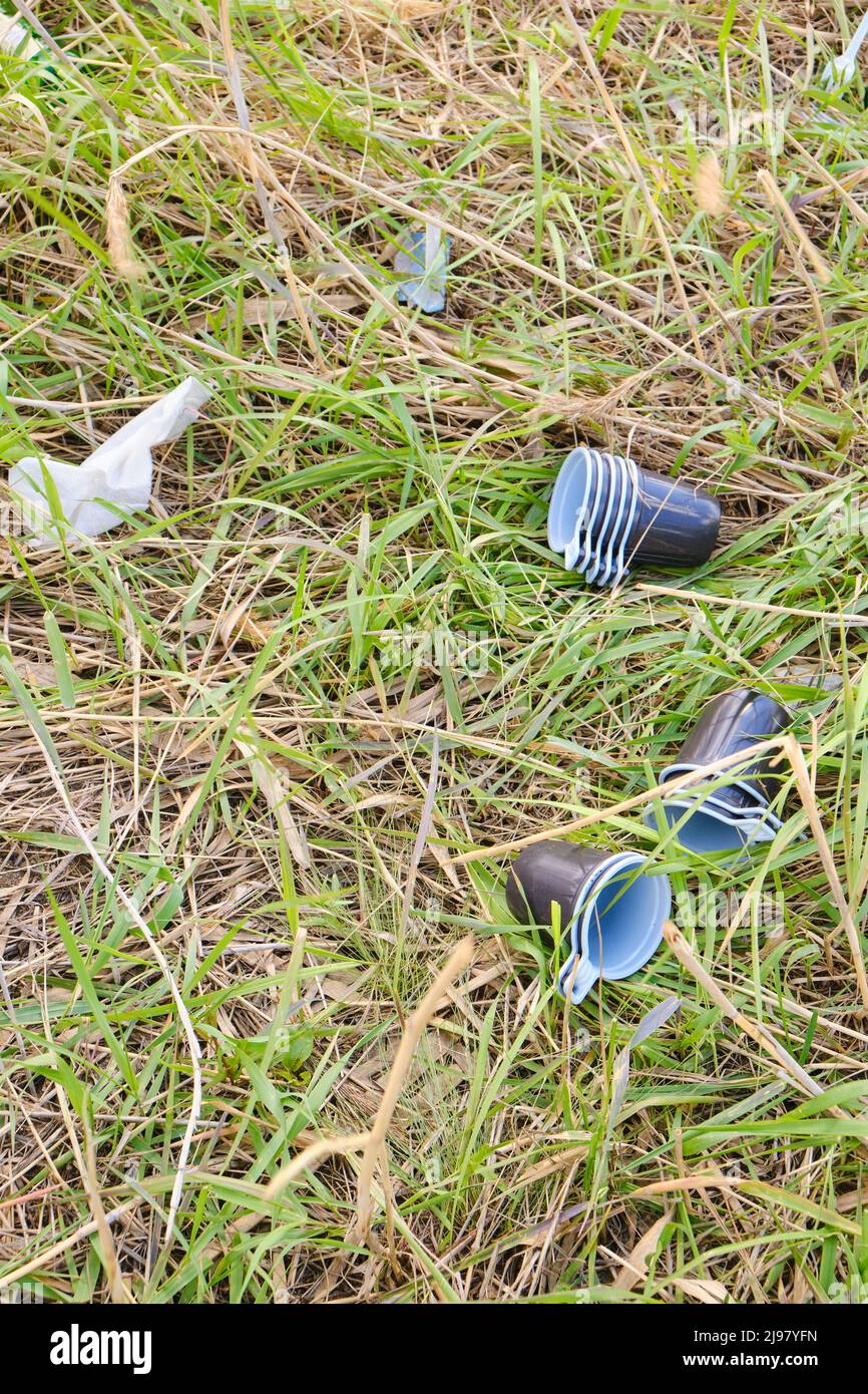 Plastic garbage thrown out green lawn Stock Photo - Alamy