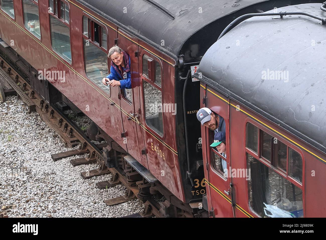 Passengers looks out of the window of a train pulling into Howarth ...