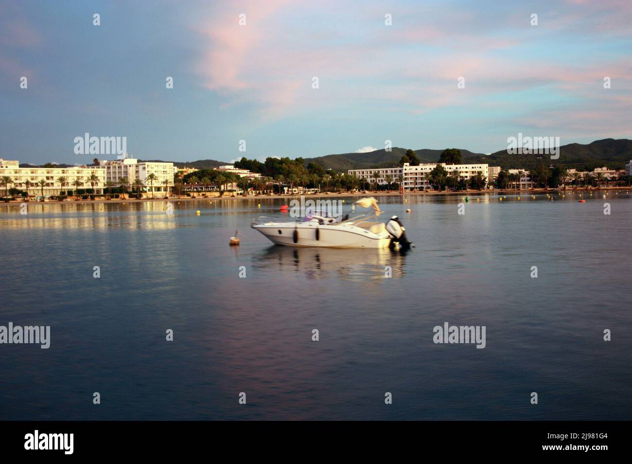sea of tourist ibiza at sunset which colors the buildings with ...