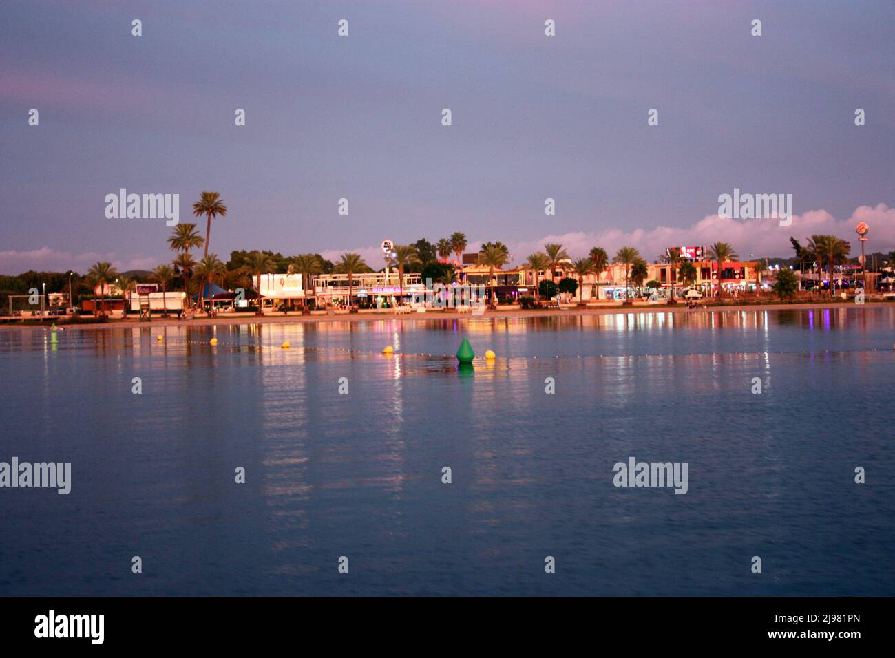 sea of tourist ibiza at sunset which colors the buildings with ...