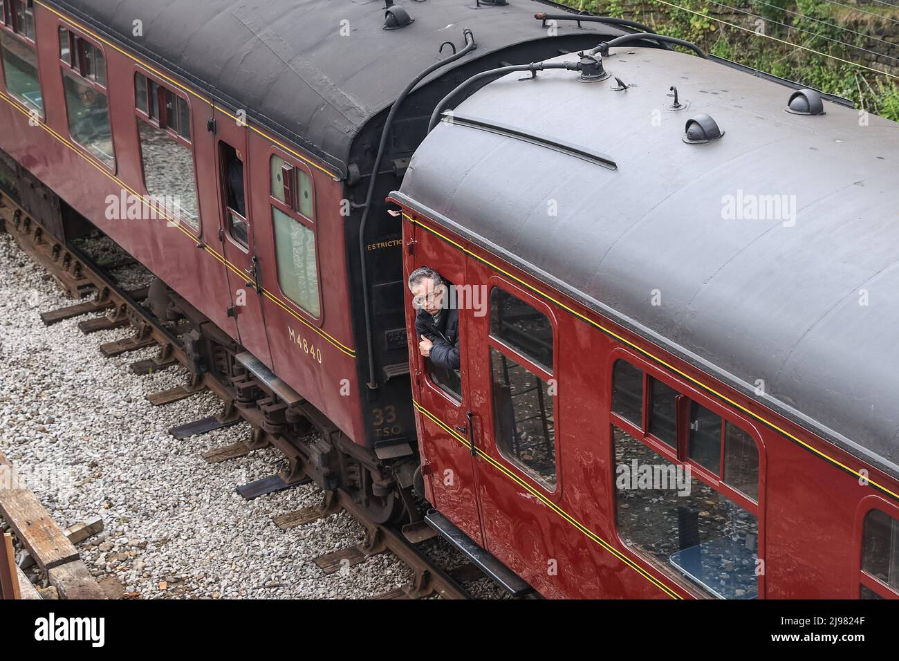 Howarth, UK. 21st May, 2022. A passenger looks out of the window of a ...