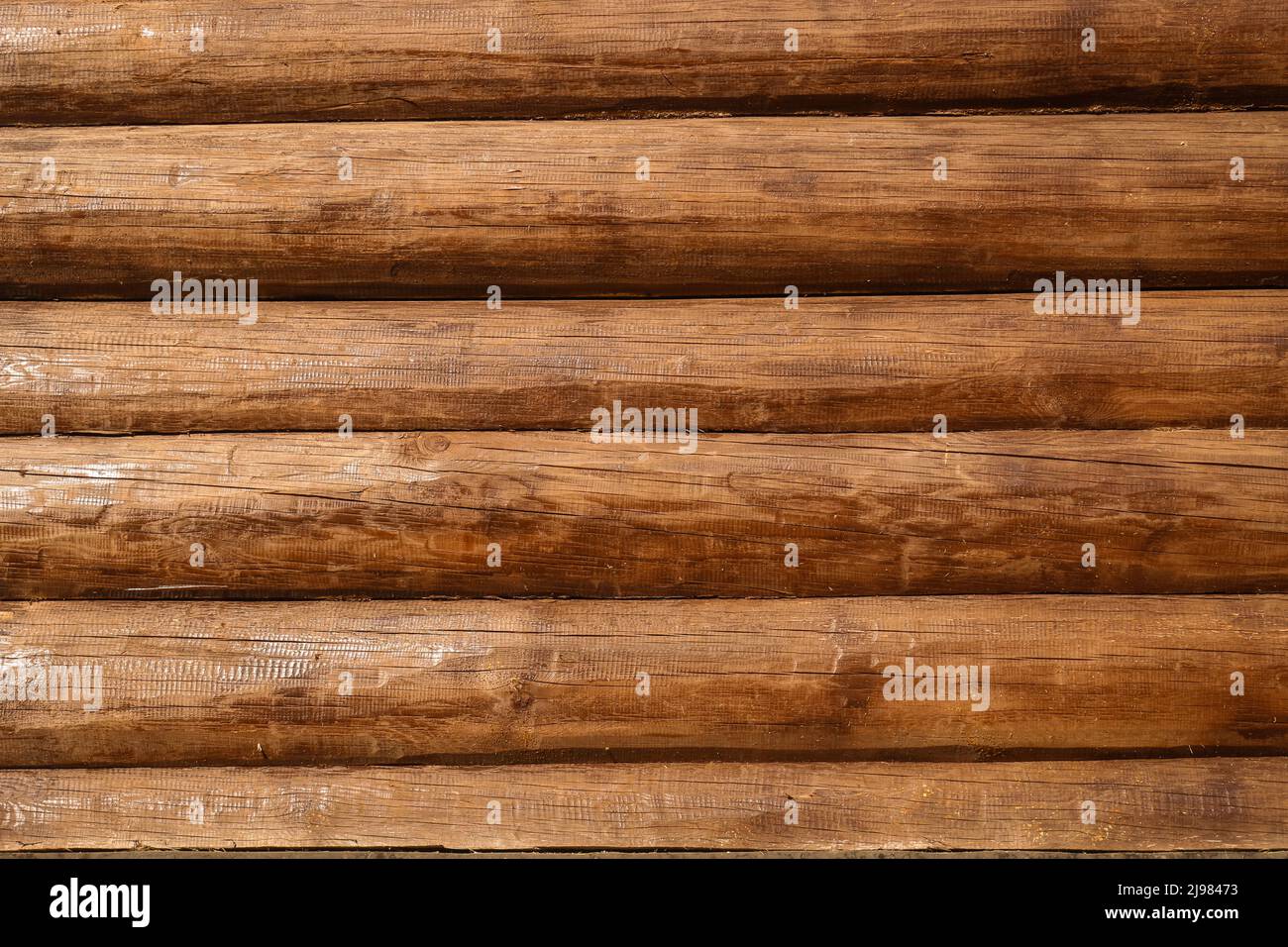 A wall of brown lacquer Logs. Textured background Stock Photo - Alamy