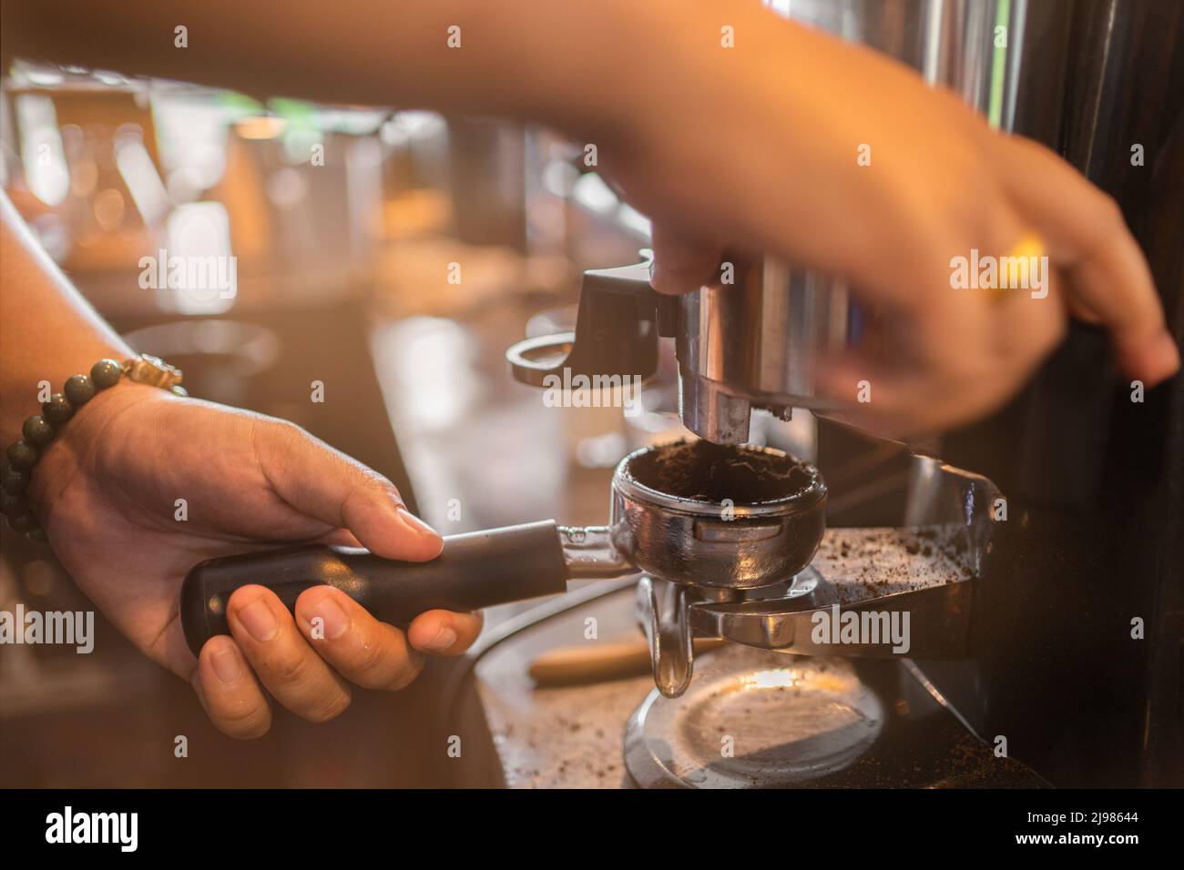 Worker works with a coffee machine Stock Photo - Alamy