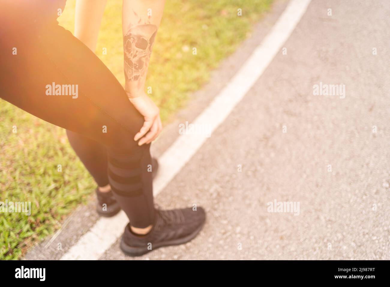 tired woman runner taking a rest after running hard Stock Photo - Alamy
