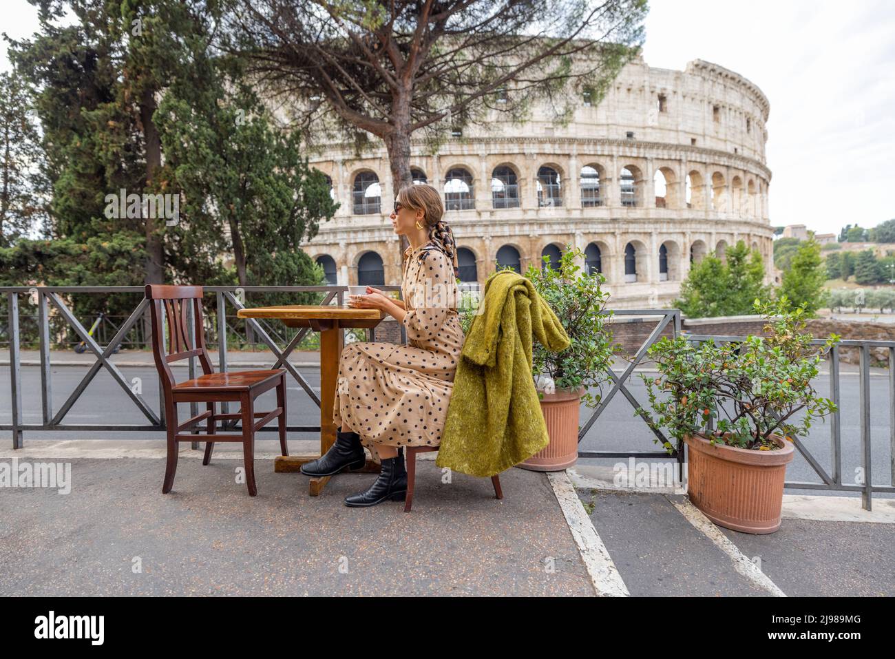 Woman at outdoor cafe in front of coliseum in Rome, Italy Stock Photo ...