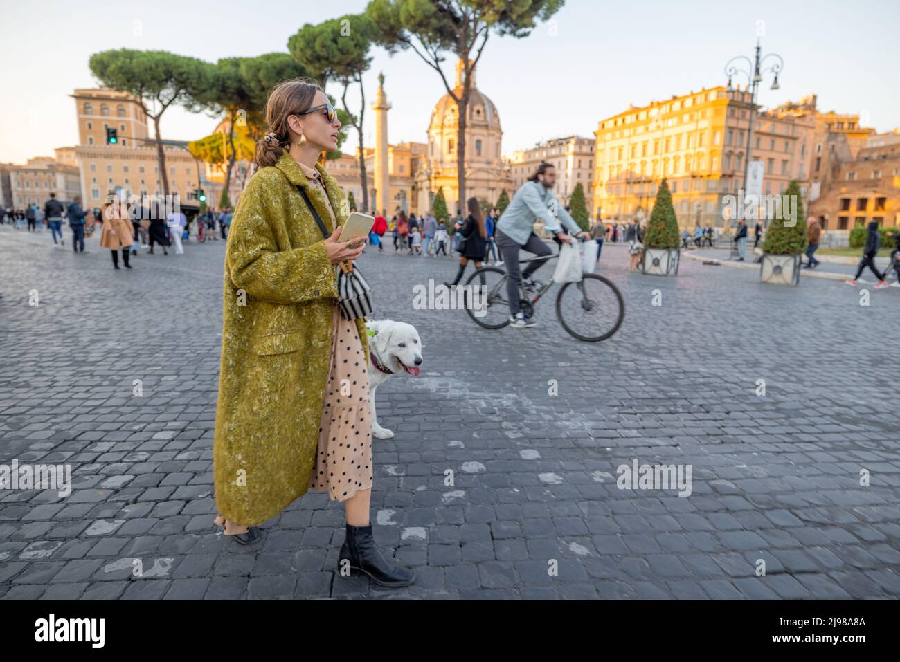 Woman walking with a dog on the famous central street in Rome Stock ...