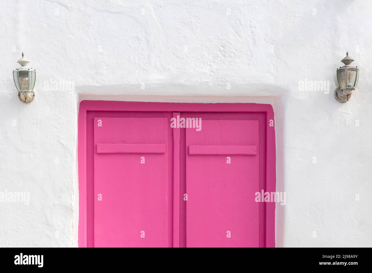 Pink windows with lamps on the sides Stock Photo - Alamy