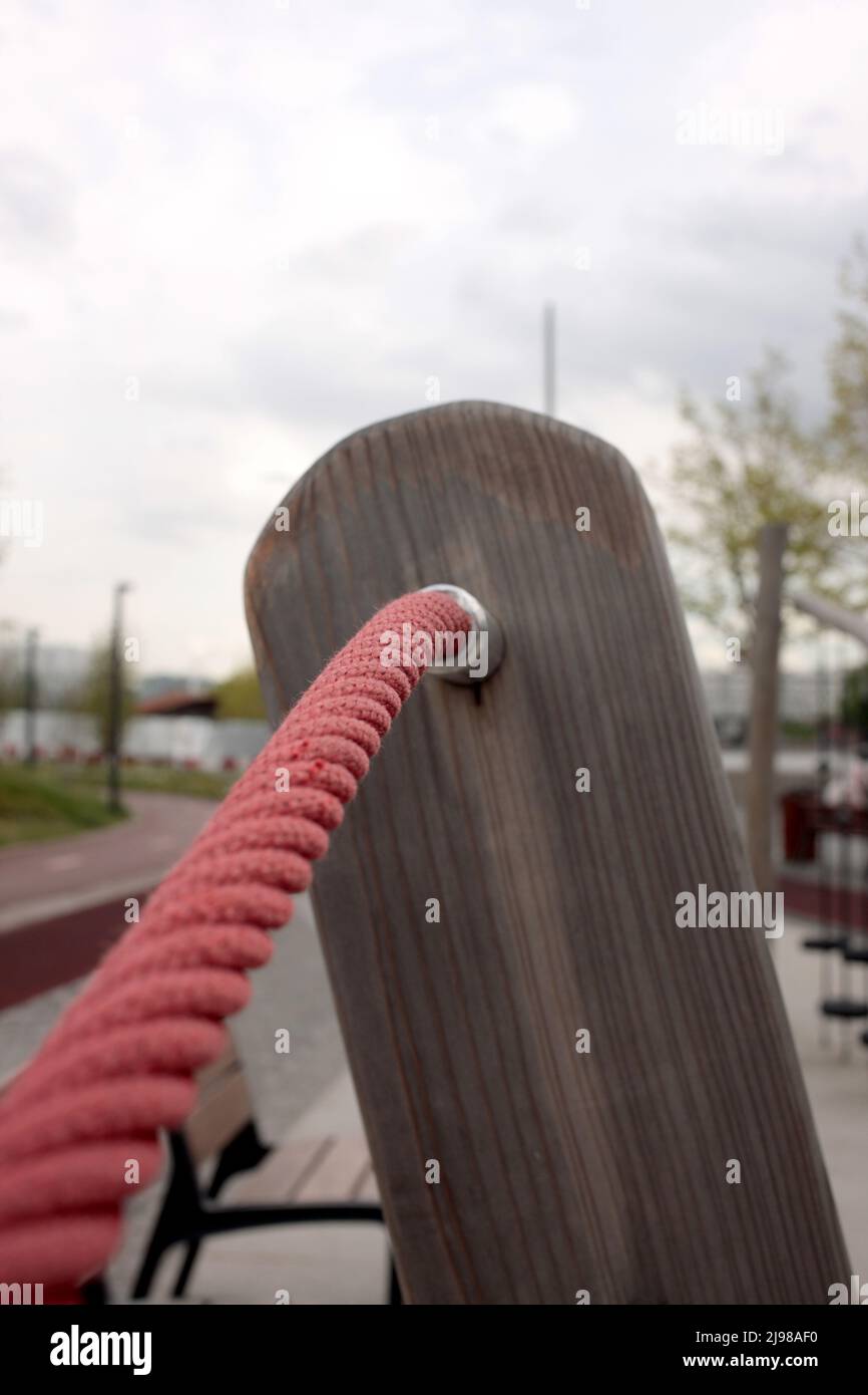 Wooden posts with ropes for decorative fencing Stock Photo - Alamy