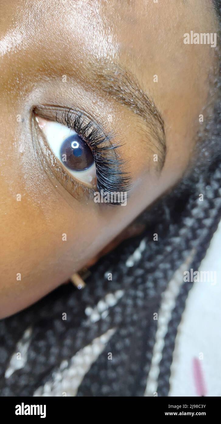 Eyelash extensions in beauty salon macro eye Stock Photo - Alamy
