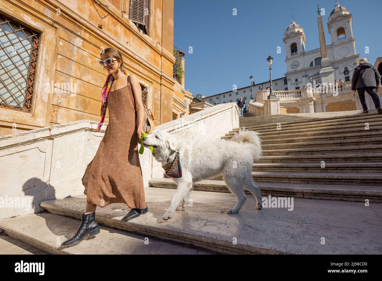 Woman running with her dog on famous Spanish steps in Rome Stock Photo ...