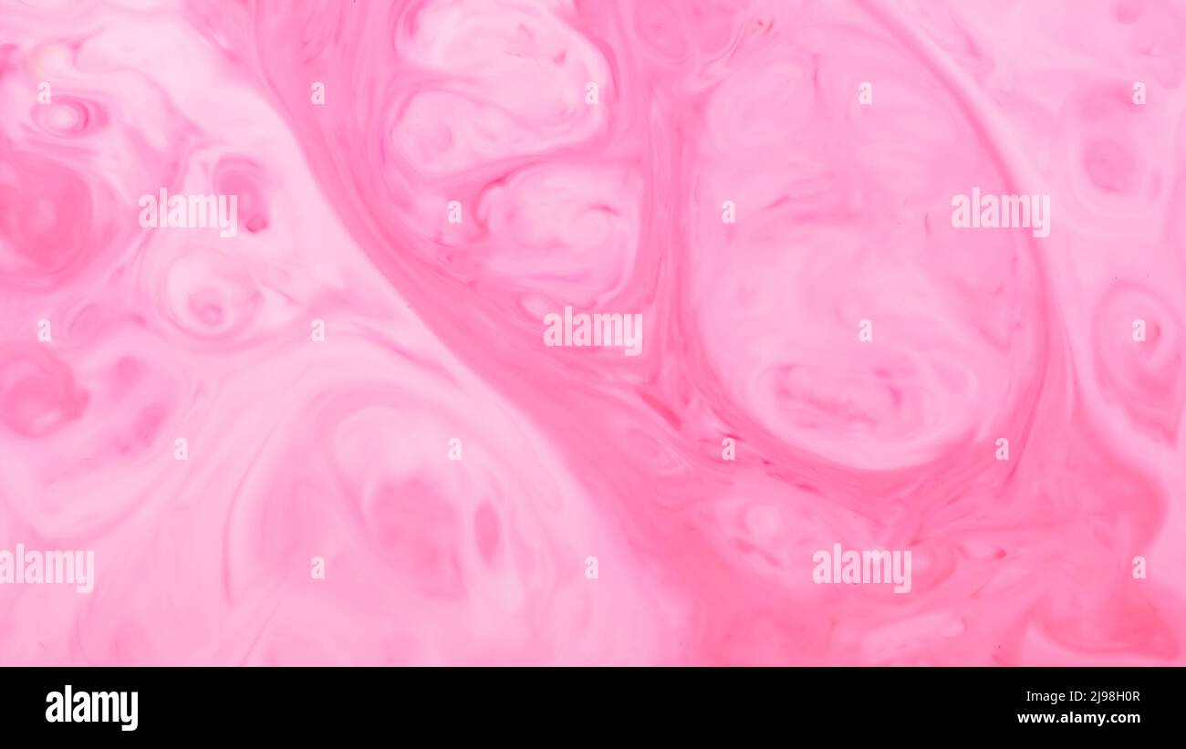Light pink fluid art background. Blurred pink shapes on a liquid ...
